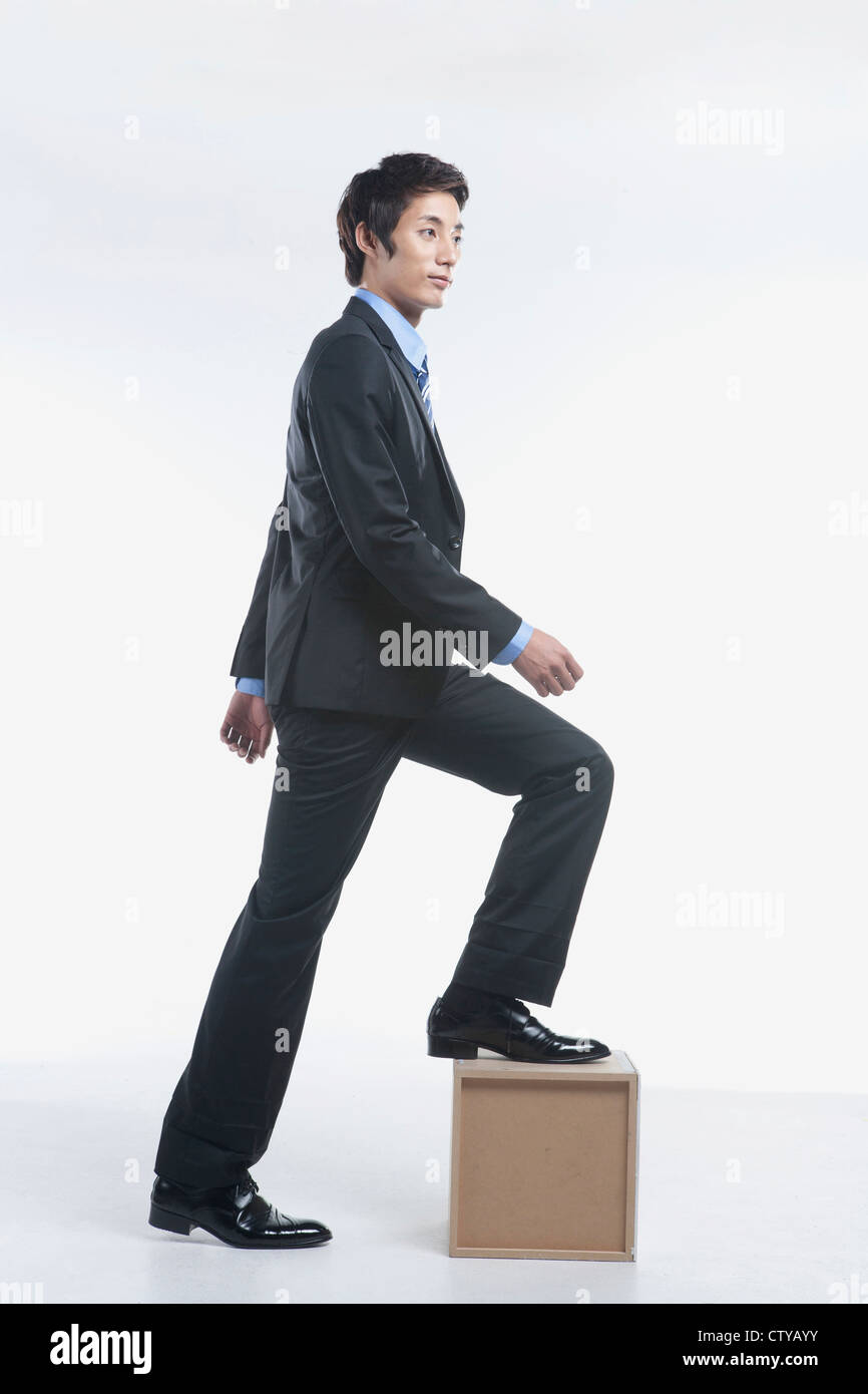 A man stepping on the box Stock Photo - Alamy