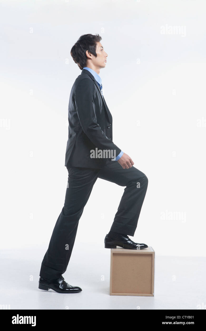 A man stepping on the box Stock Photo - Alamy