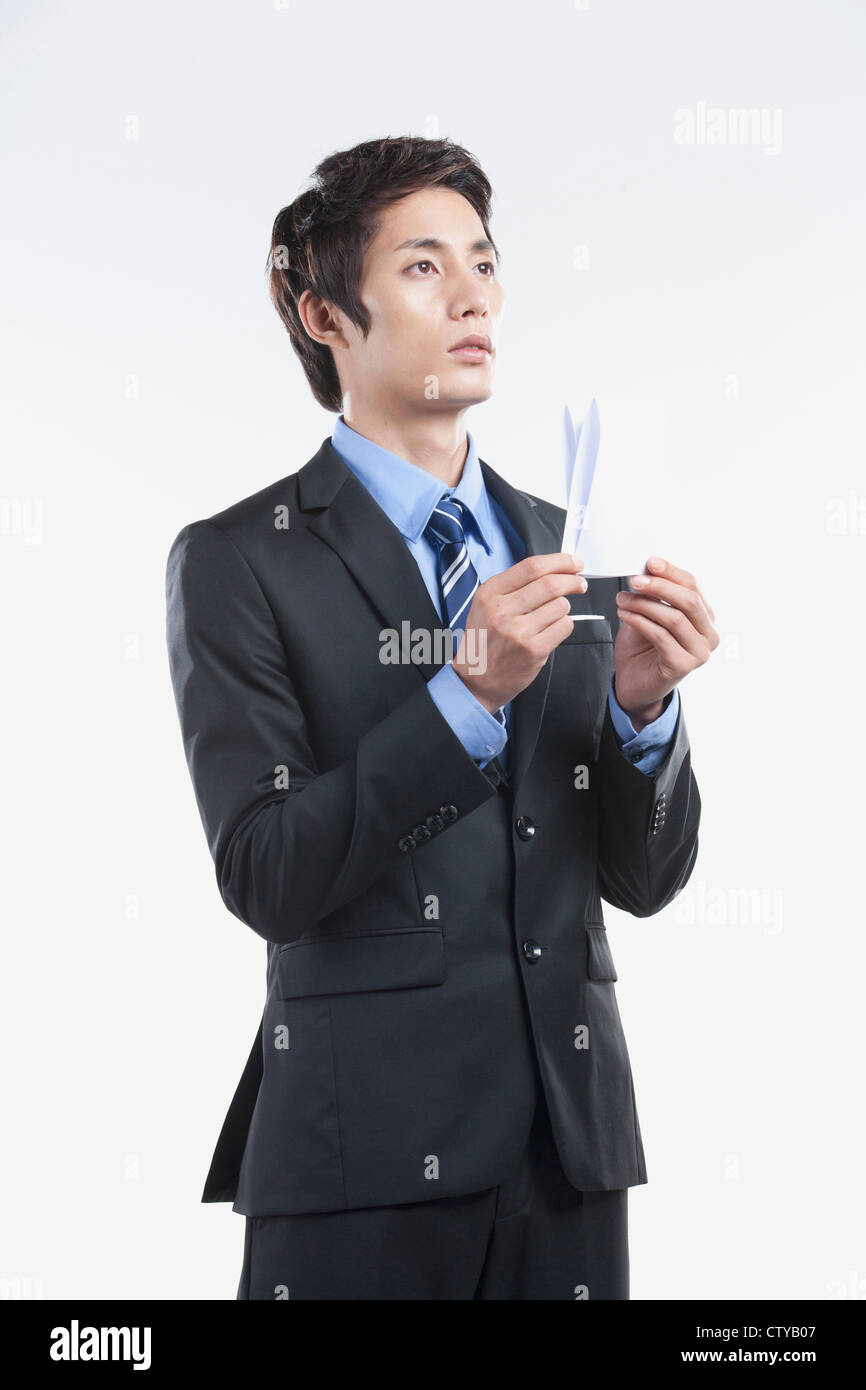 A man holding the folded paper Stock Photo - Alamy