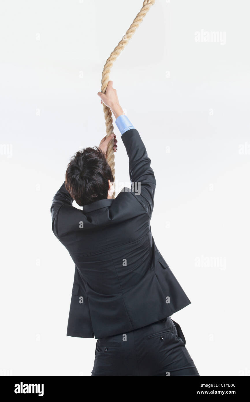 A man pulling the rope Stock Photo - Alamy