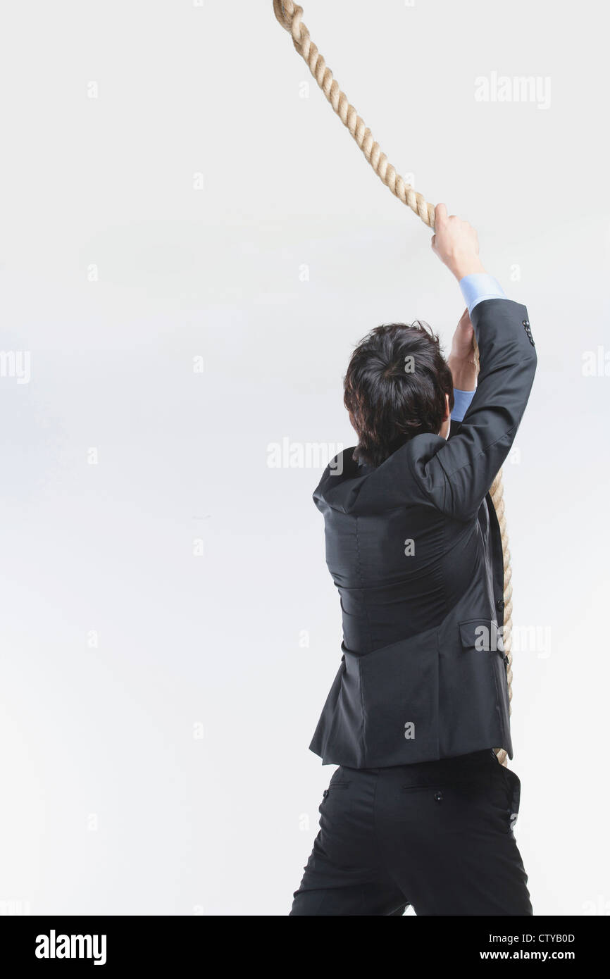 A man pulling the rope Stock Photo - Alamy
