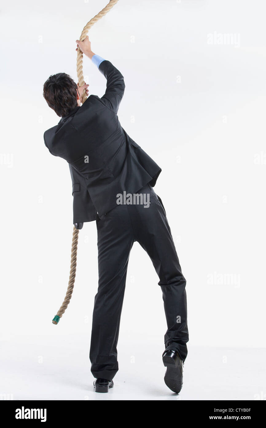 Asian man pulling rope hi-res stock photography and images - Alamy