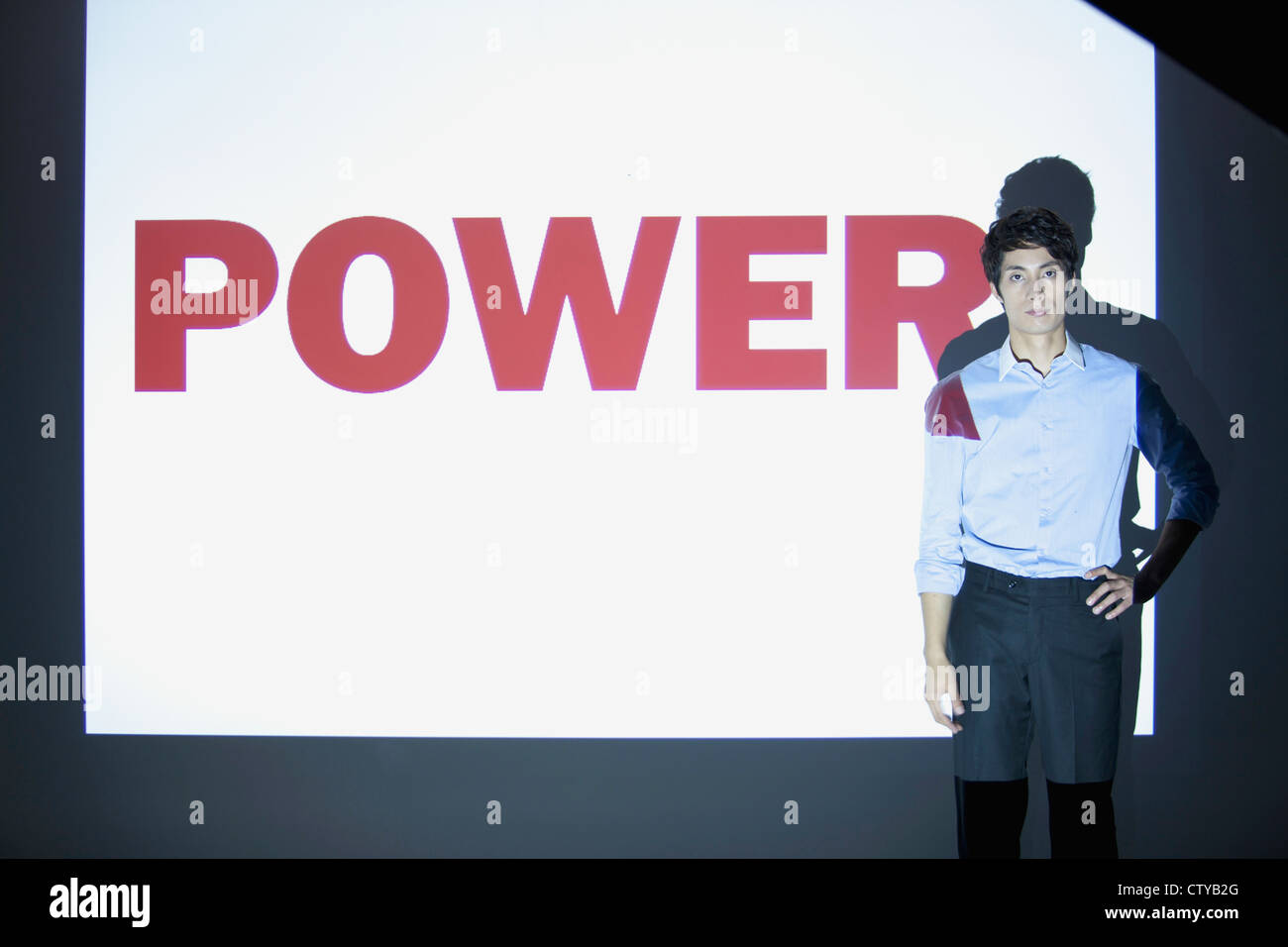 A man standing by power presentation slide Stock Photo - Alamy