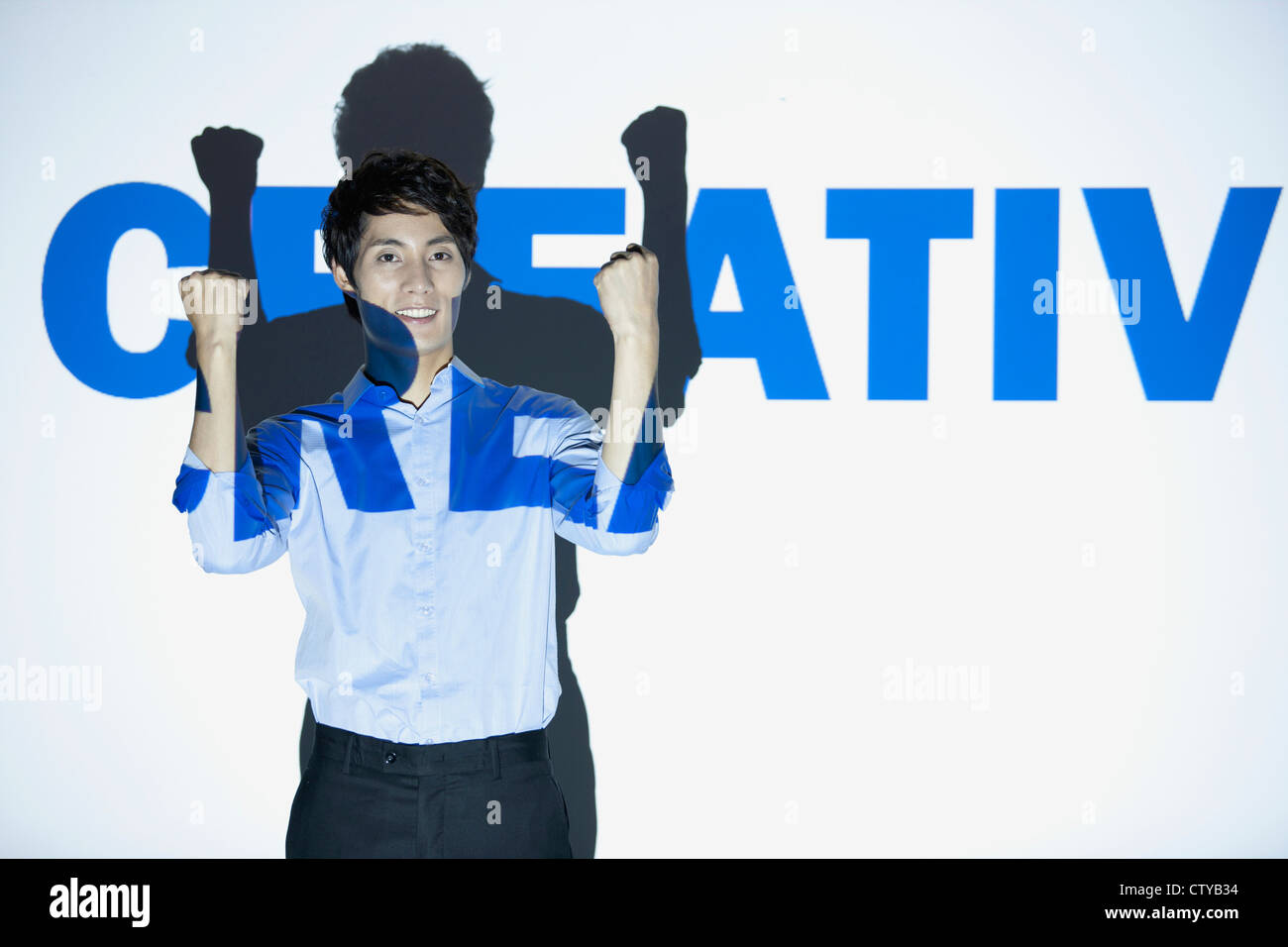 A cheerful man with 'creative' presentation slide Stock Photo - Alamy