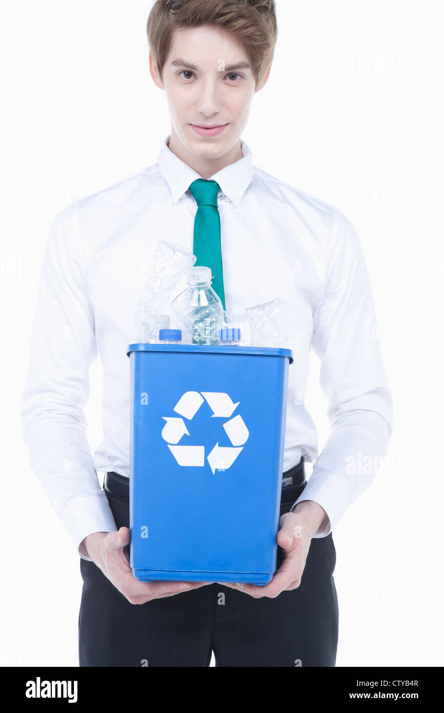 A man holding a recycling bin Stock Photo - Alamy
