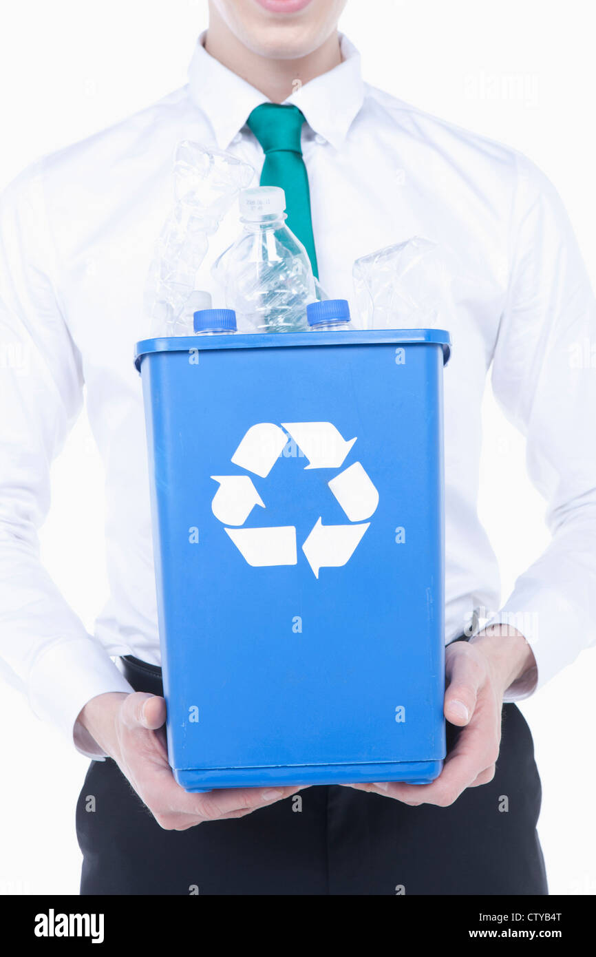 A man holding a recycling bin Stock Photo - Alamy