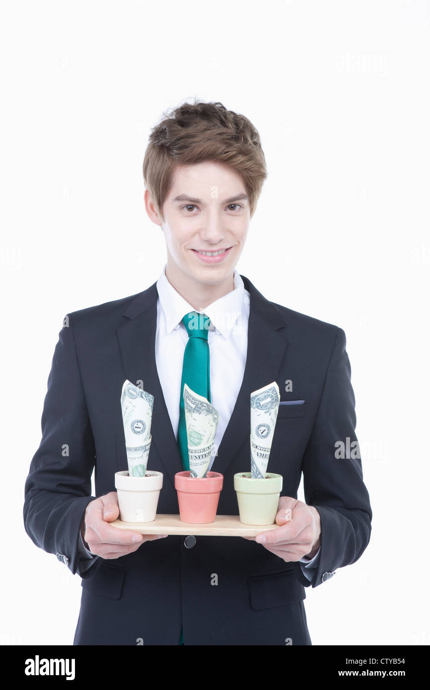 A man holding the money pot Stock Photo - Alamy