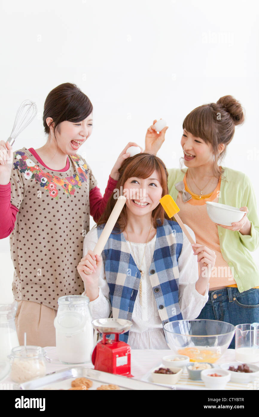 Three women baking Stock Photo - Alamy