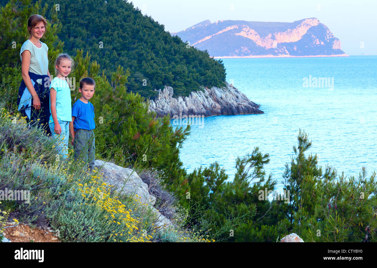 Pink sea sunset, Island on horizon and family on hill (summer view from ...