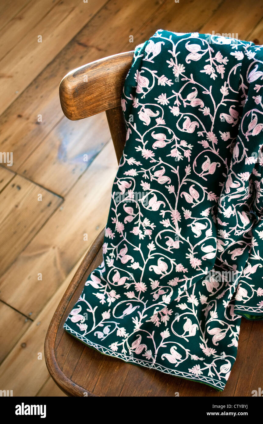 Embroidered jacket thrown over a chair Stock Photo - Alamy