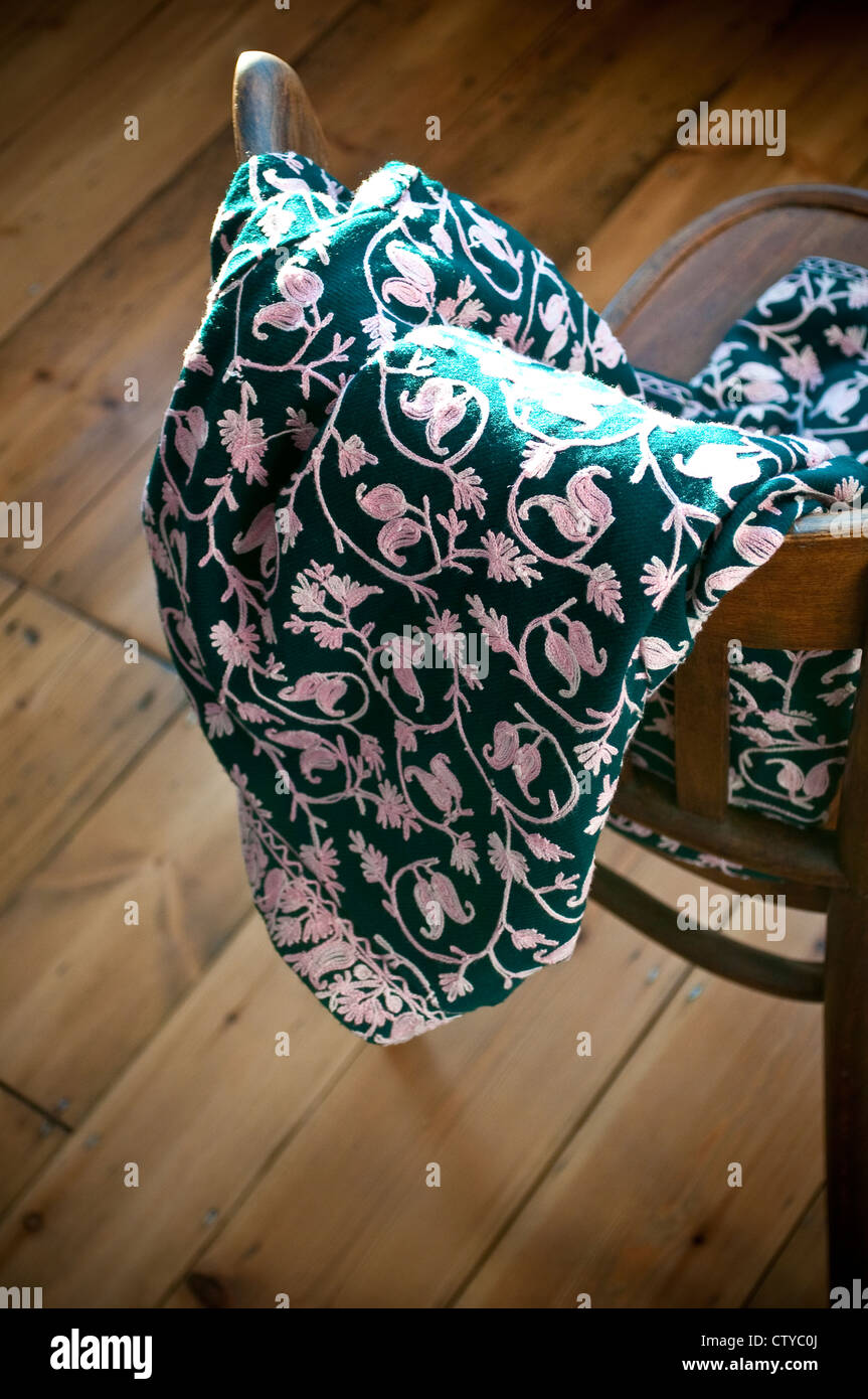 Embroidered jacket thrown over a chair Stock Photo - Alamy