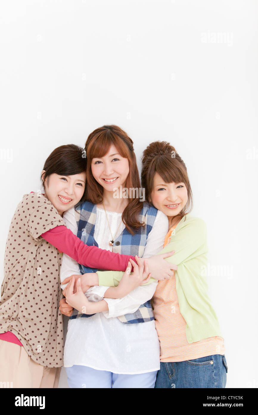 Three women hugging each other Stock Photo - Alamy