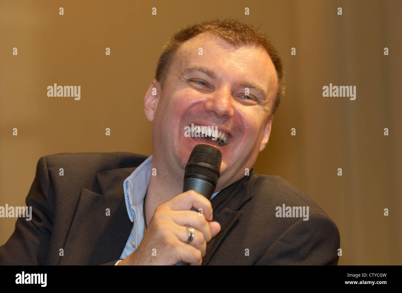 smiling man adressing a conference Stock Photo - Alamy