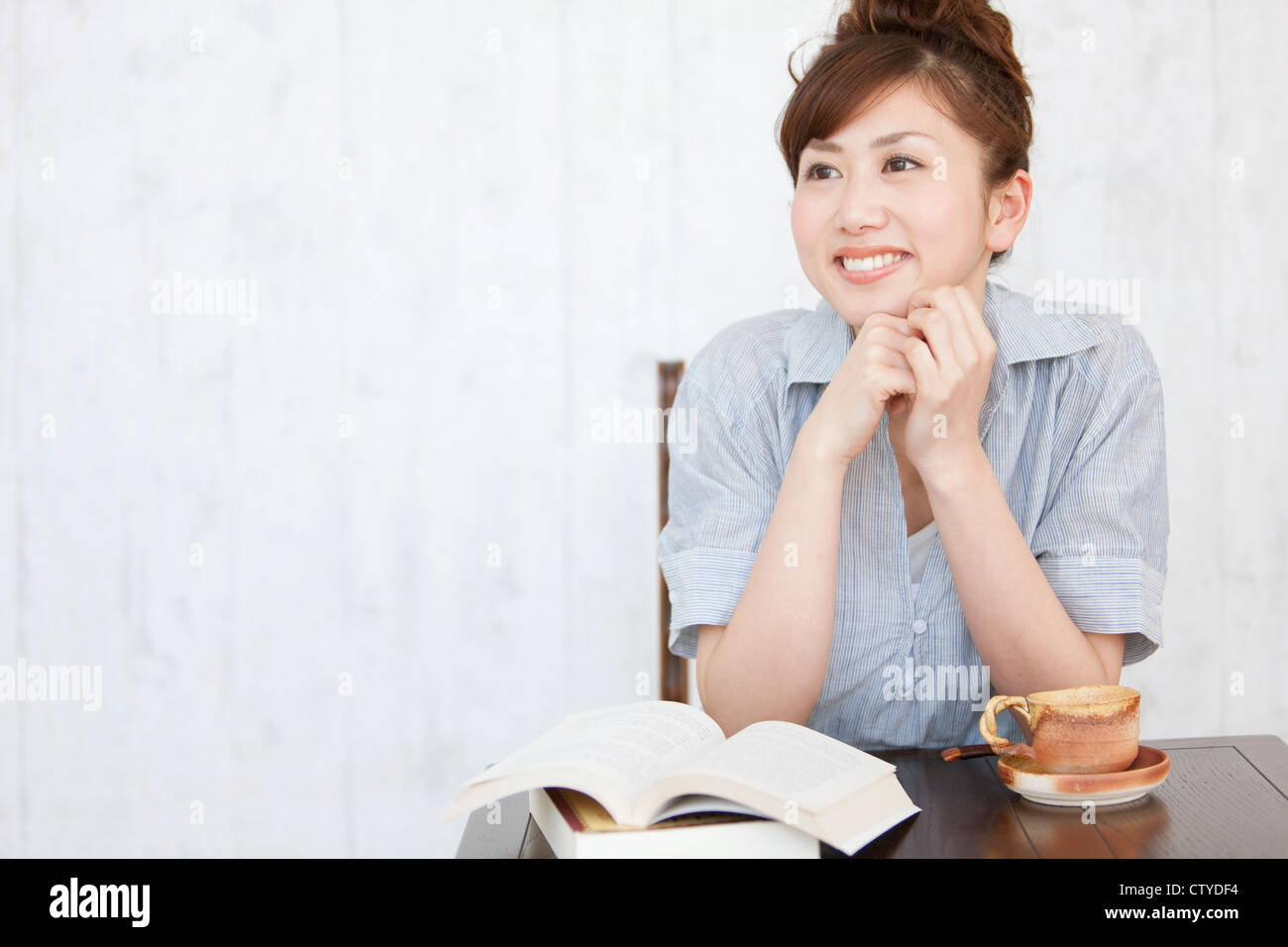 Young woman smiling with coffee Stock Photo - Alamy