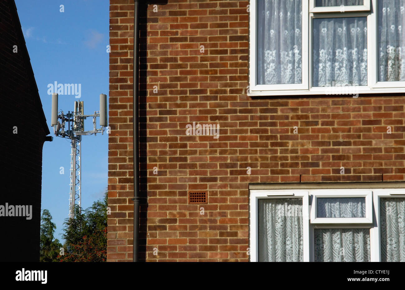 Telephone mast near houses Stock Photo - Alamy