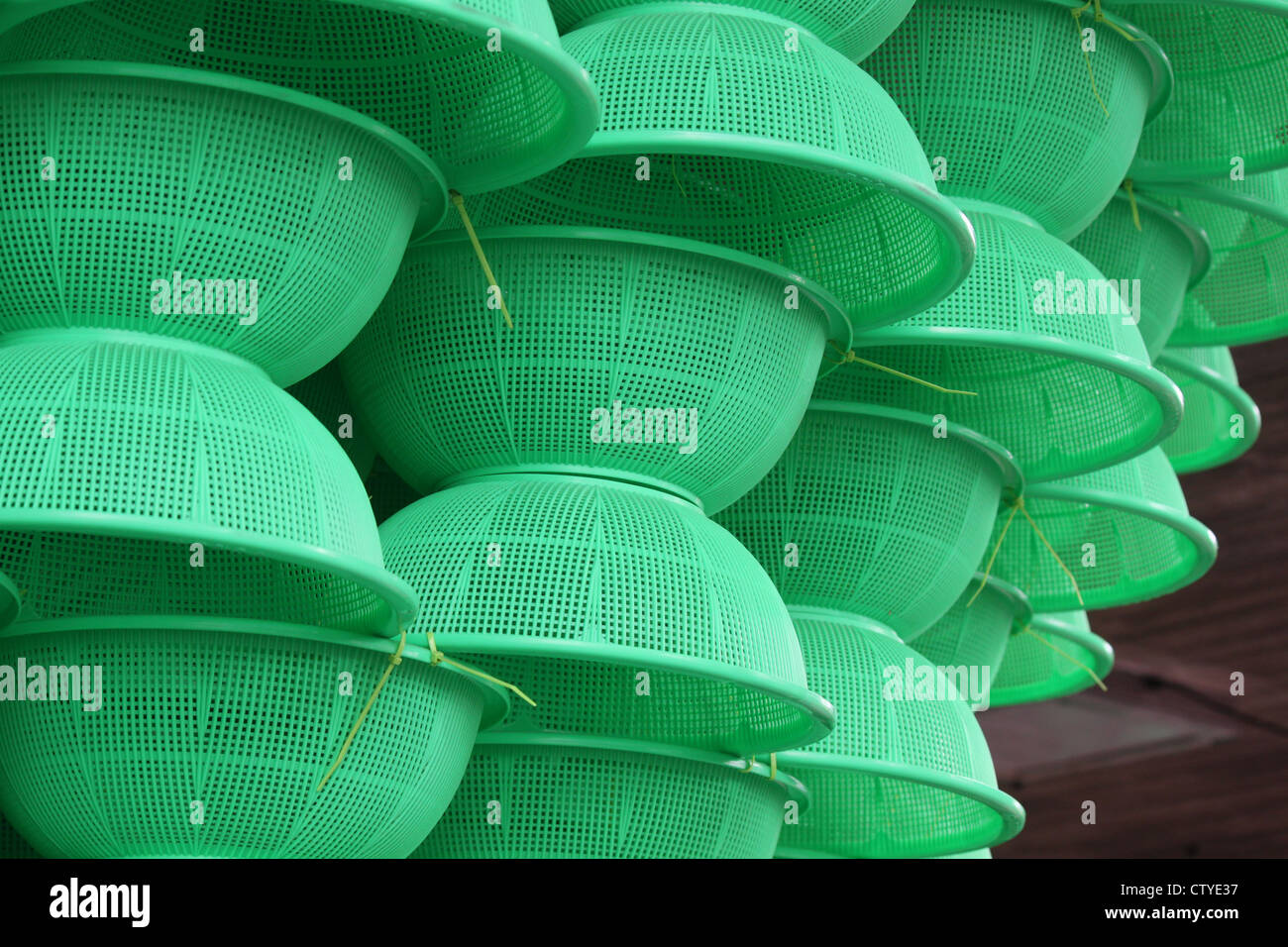 Pile of green colanders Stock Photo - Alamy