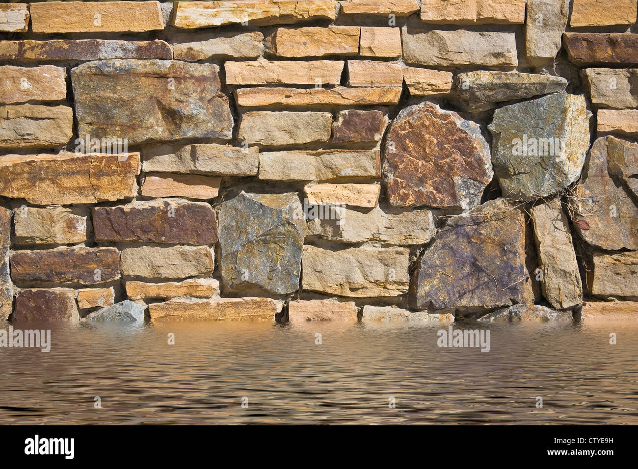 Stone wall and water Stock Photo - Alamy