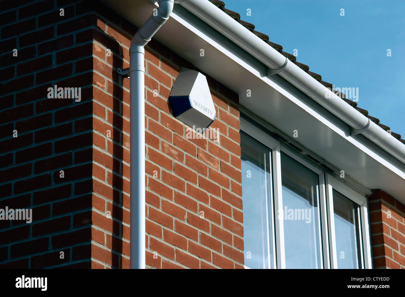 Alarm system showing on the side of a house England UK Stock Photo - Alamy