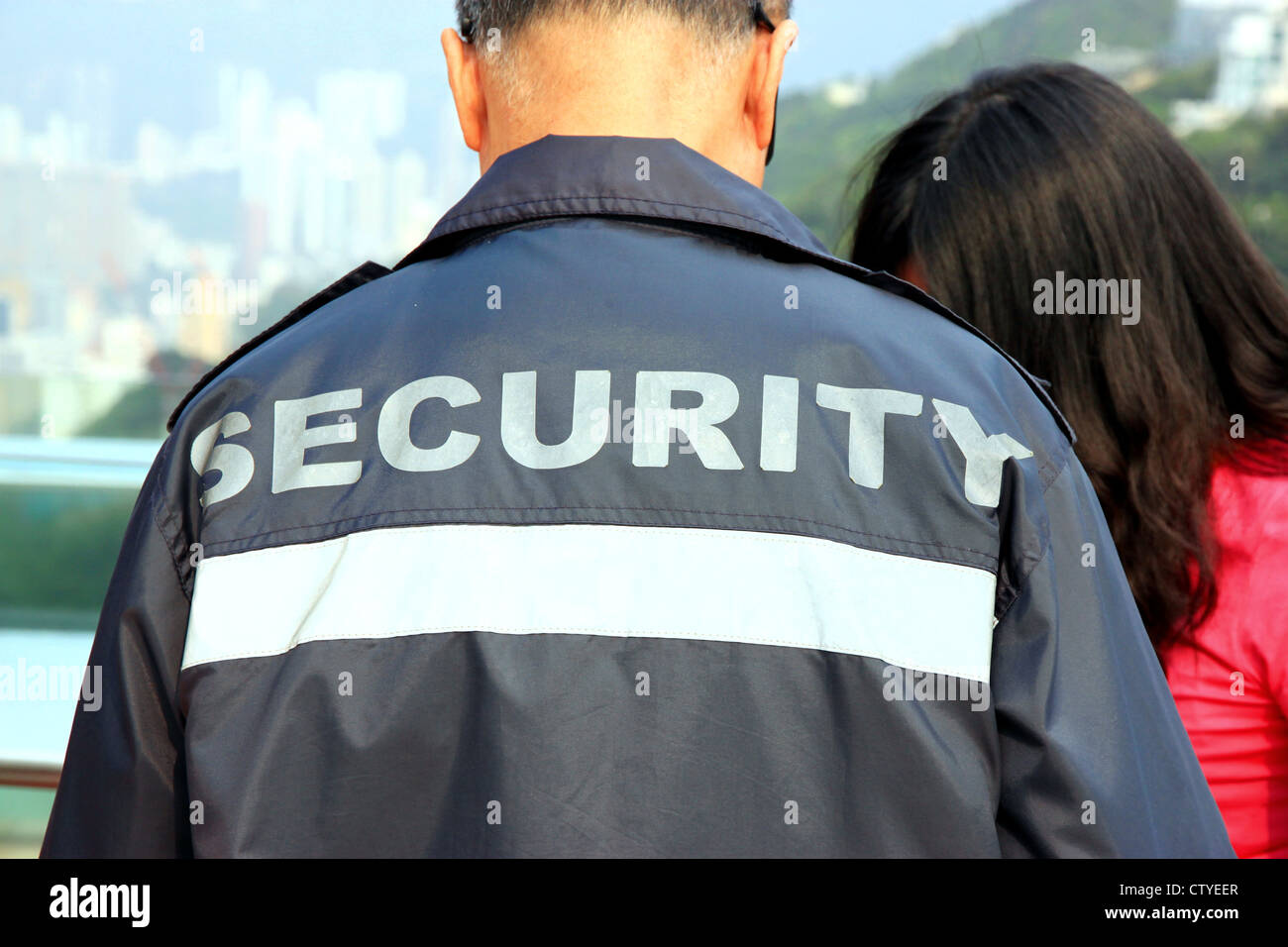 A security professional helping people Stock Photo - Alamy