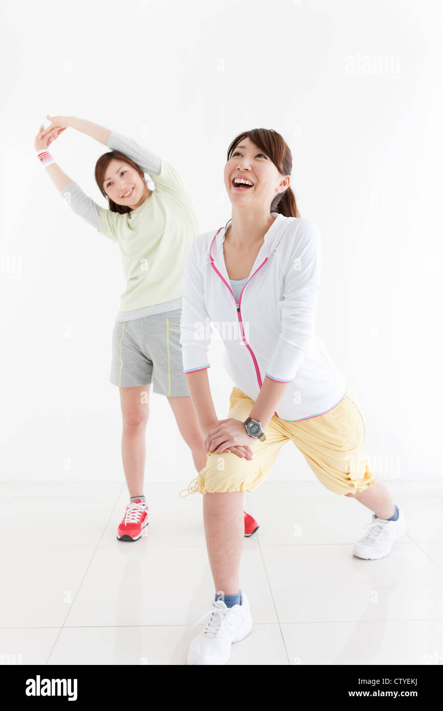 Two young women stretching Stock Photo - Alamy