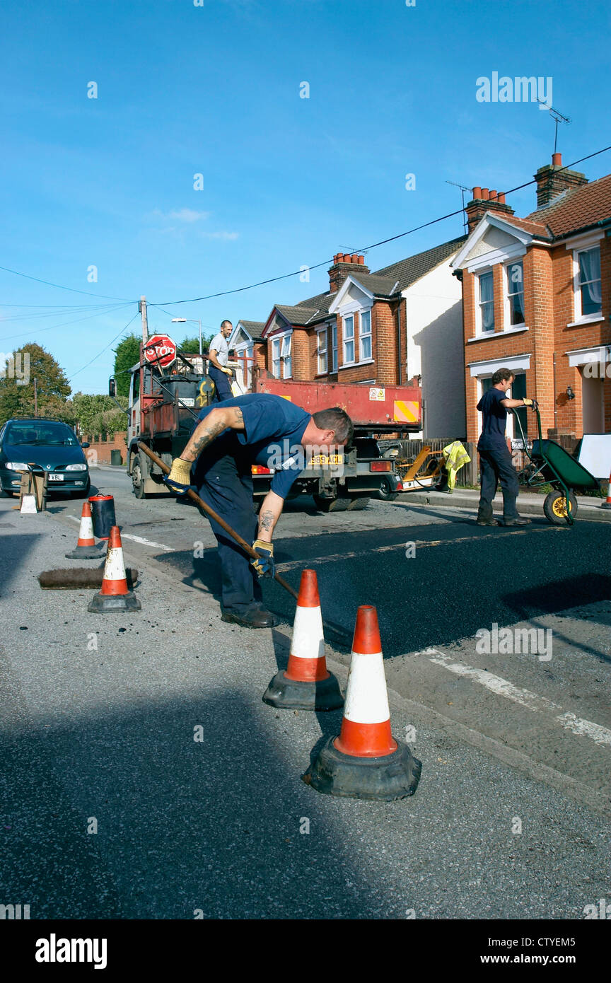 Spreading hot asphalt. Resurfacing street England UK Stock Photo - Alamy