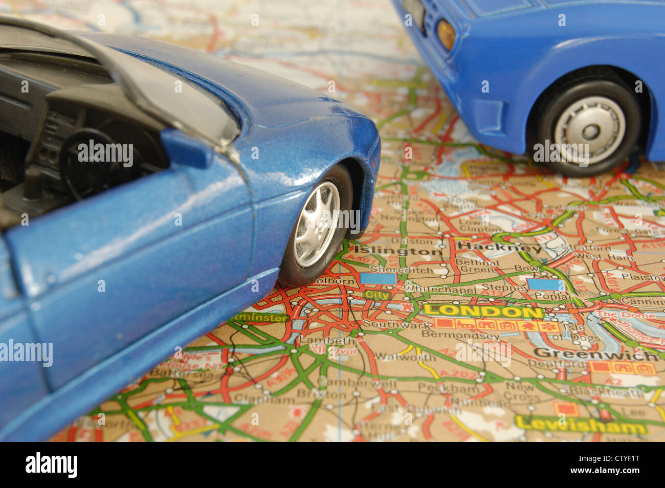 Blue model cars on a route map of Greater London Stock Photo - Alamy