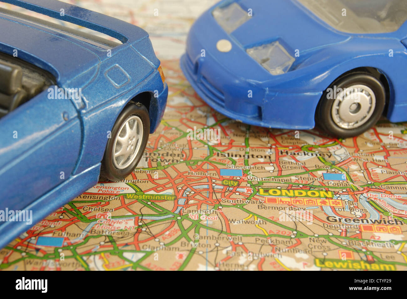 Blue model cars on a route map of Greater London Stock Photo - Alamy