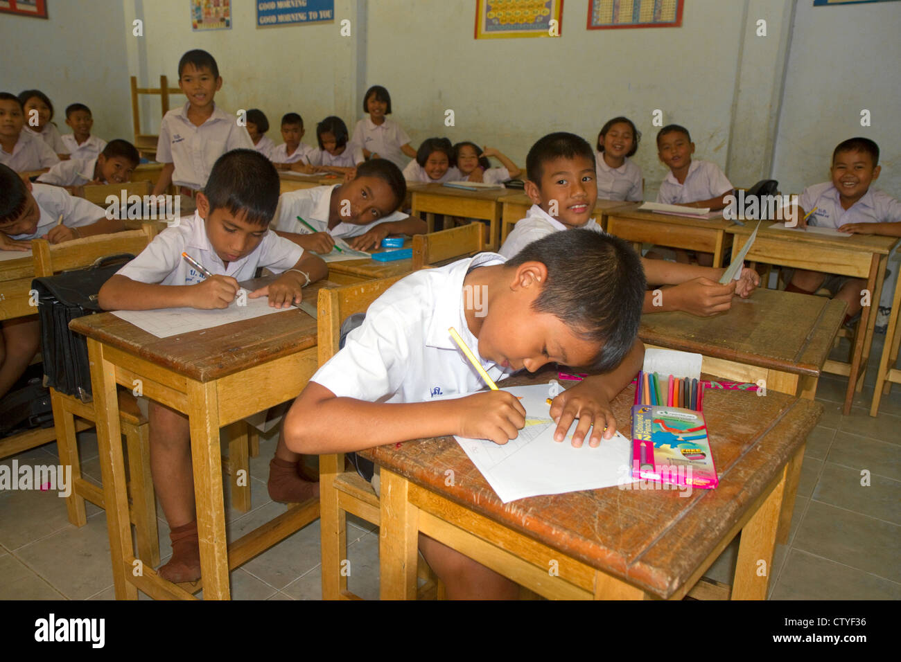 Thai elementary school students sit a desks on the island of Ko Samui ...