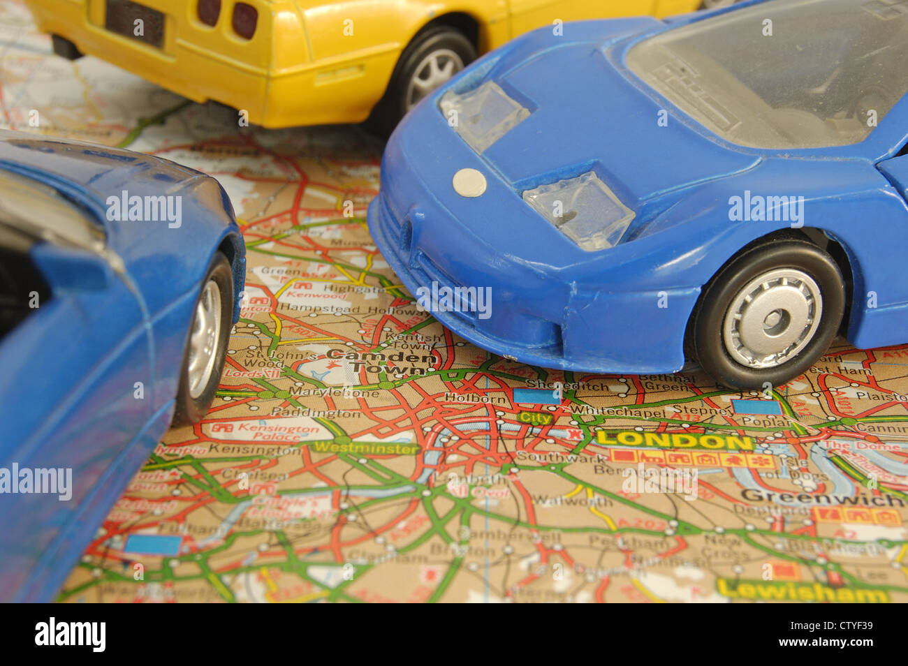 Model cars on a route map of Greater London Stock Photo - Alamy
