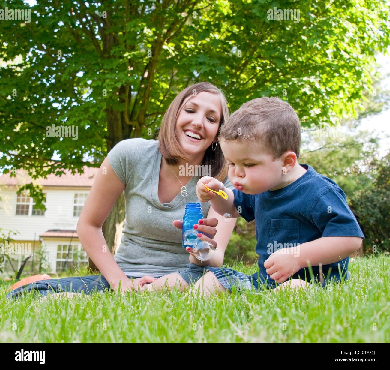2 And A Half Year Old Boy And His Mom Blowing Bubbles In The Backyard 2-and-a-half-year-old-boy-and-his-mom-blowing-bubbles-in-the-backyard