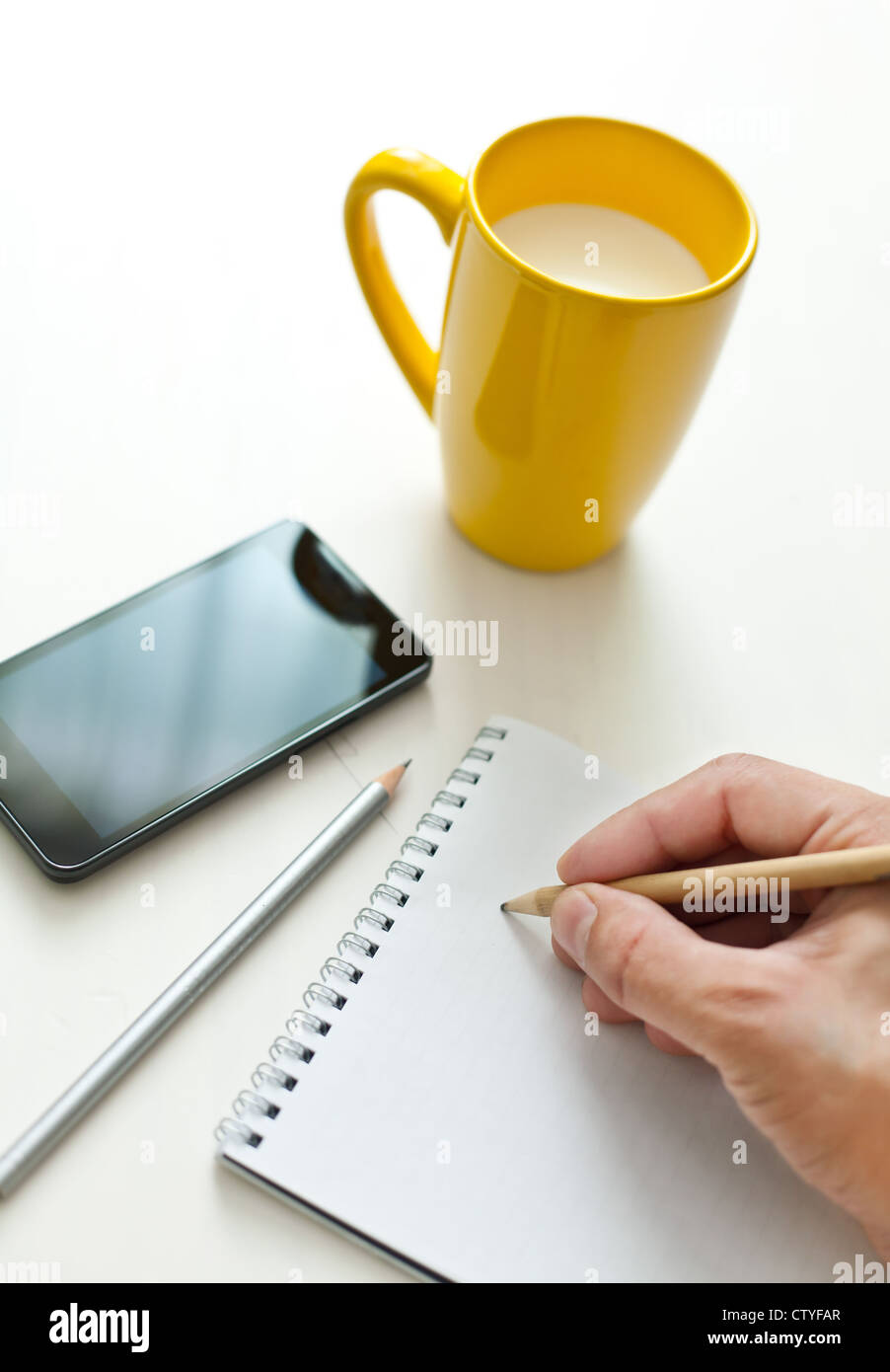 Writing notes or planning a schedule on blank spiral notebook Stock ...