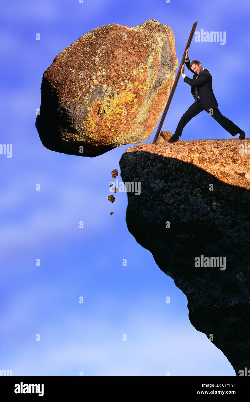 Businessman pushing rock off cliff Stock Photo - Alamy Businessman pushing rock off cliff Stock Photo - Alamy