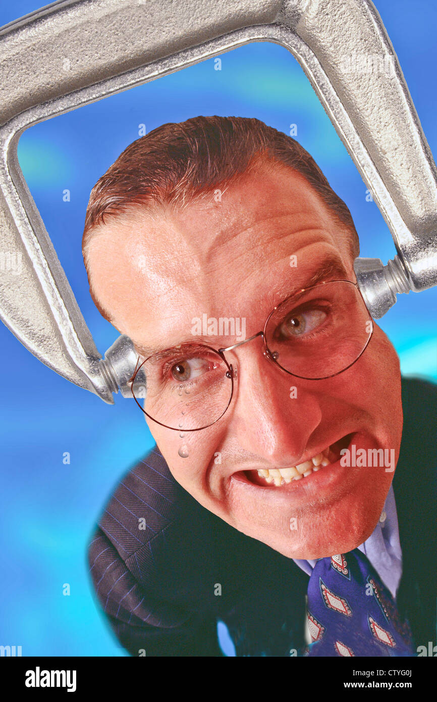 Businessman head squeezed in vise Stock Photo - Alamy