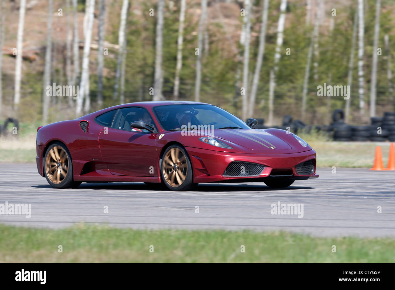 Red Ferrari on the race track Stock Photo - Alamy