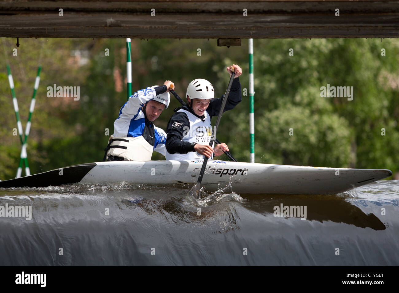 Cross Canoe paddlers in a stream Stock Photo - Alamy