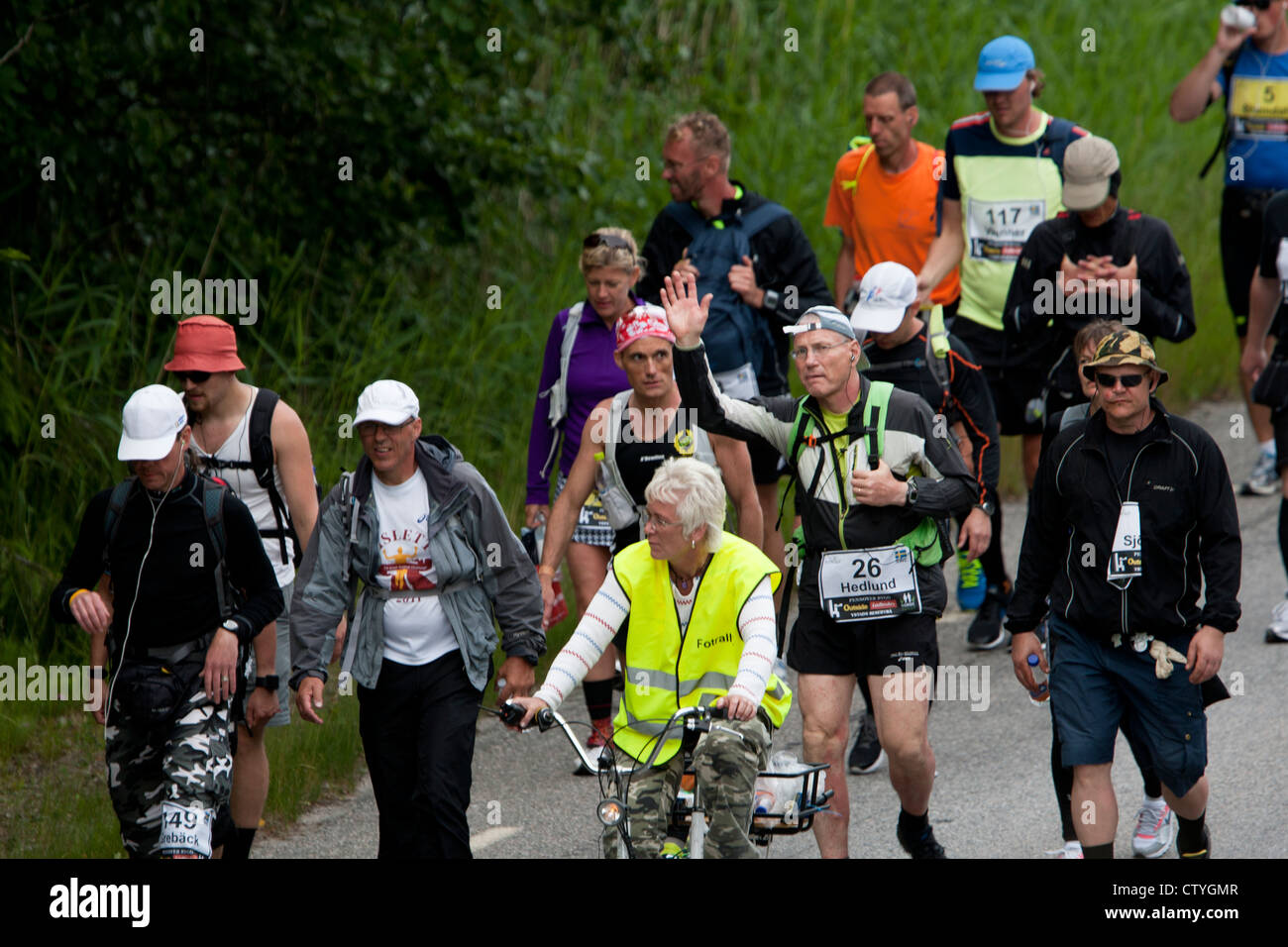 Walking racing on a highway with lots of people Stock Photo - Alamy