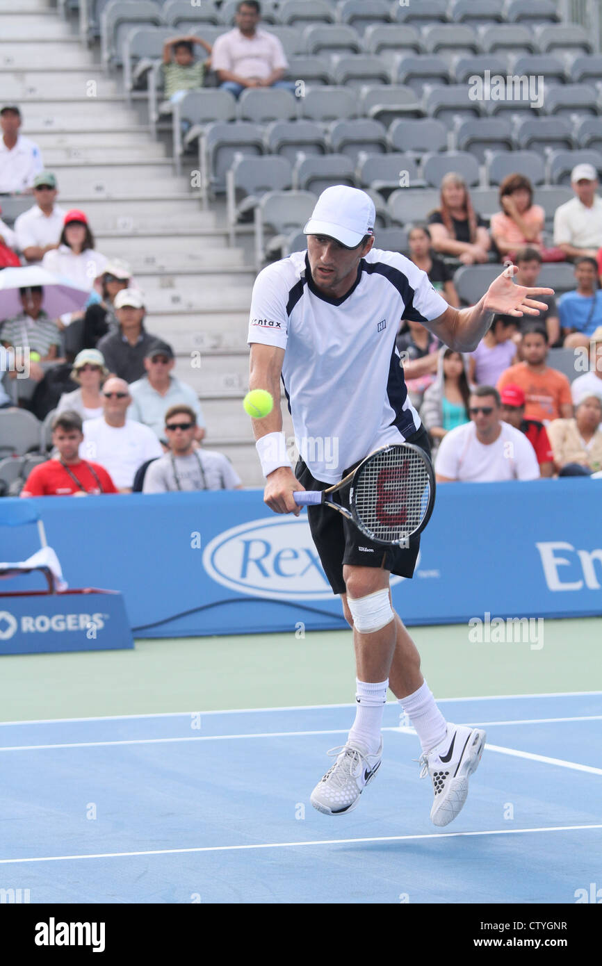 tennis action man playing backhand return Stock Photo - Alamy