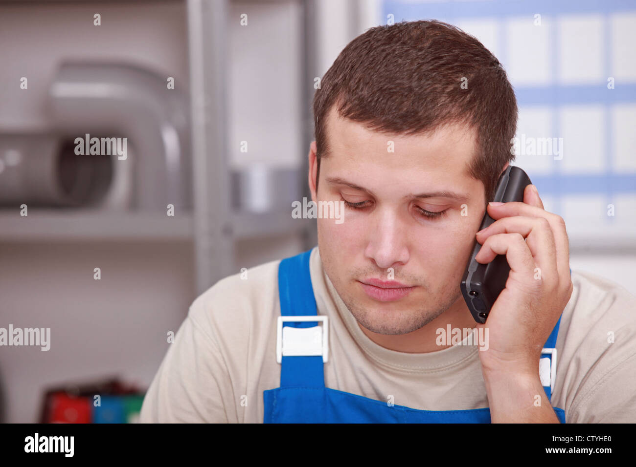Plumbers merchant on the phone Stock Photo - Alamy