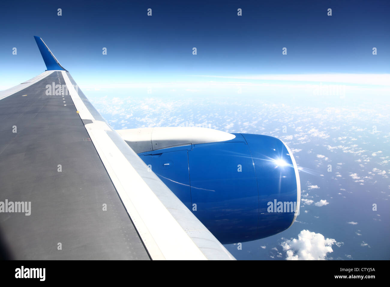 airplane fly in blue sky cloud around Stock Photo - Alamy