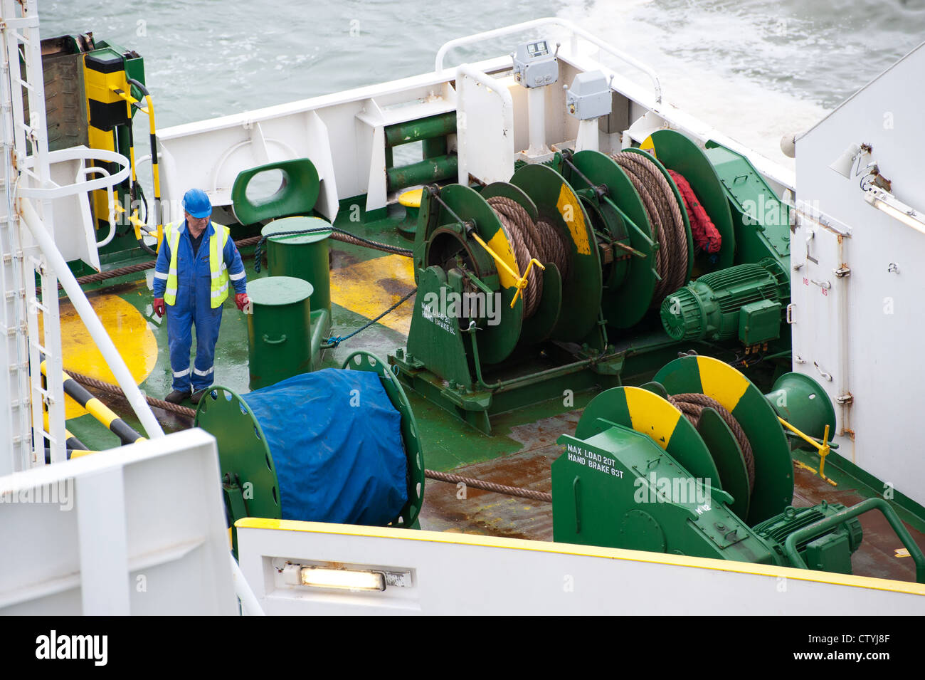 A Car ferry worker taking in rope prior to setting sail Stock Photo - Alamy