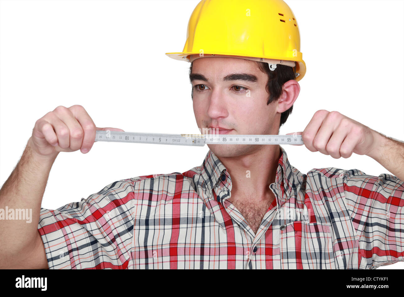 Builder holding measuring tape Stock Photo - Alamy