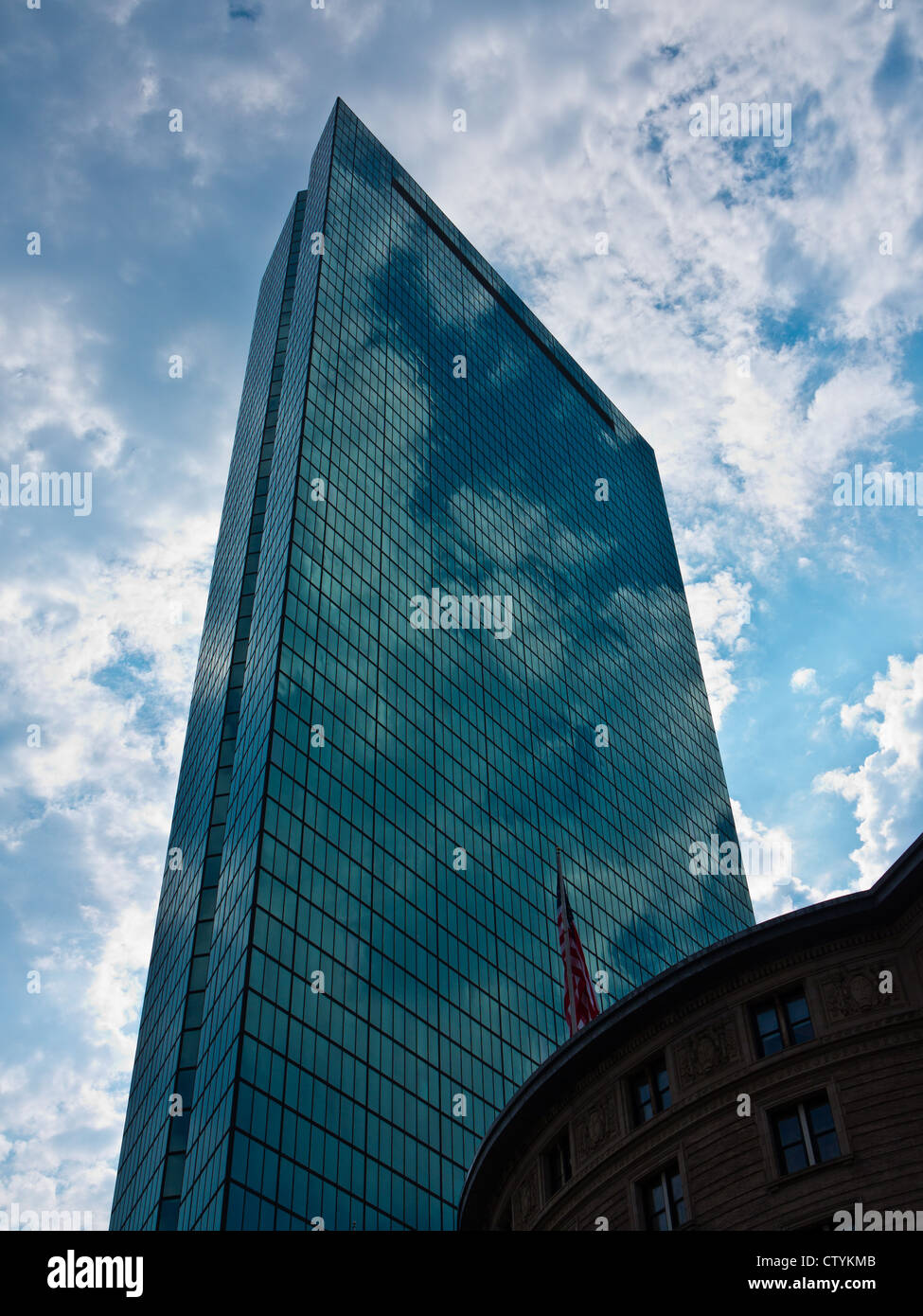 Sky and clouds reflect in a glass covered building in Boston ...