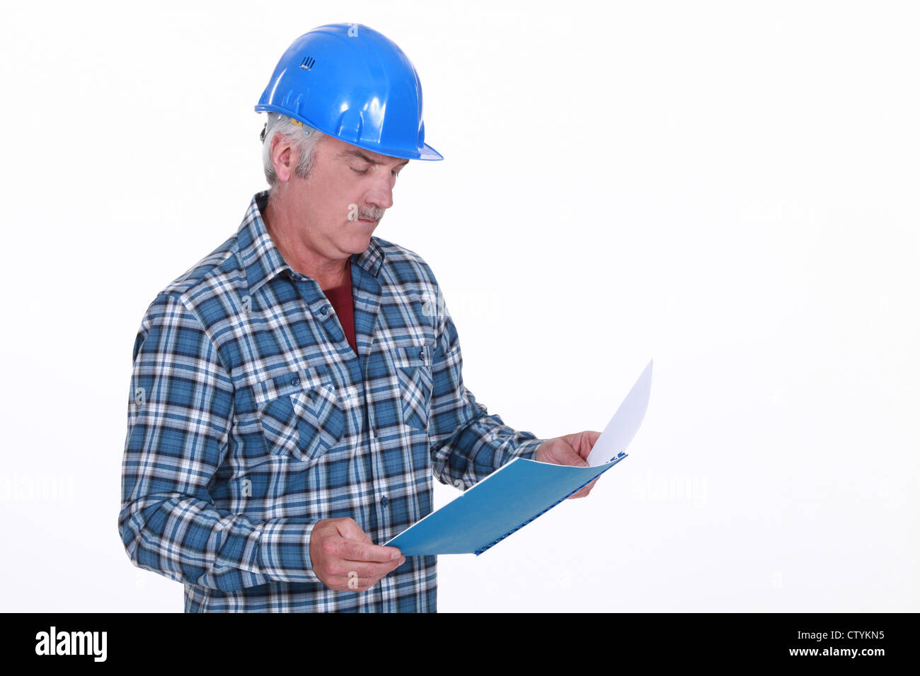 Engineer reading a report Stock Photo - Alamy