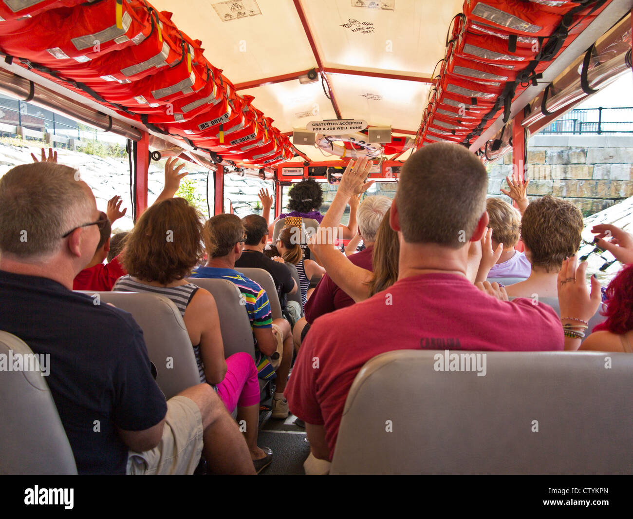 Passengers on amphibious vehicle of the Boston Duck Tour on the Charles ...