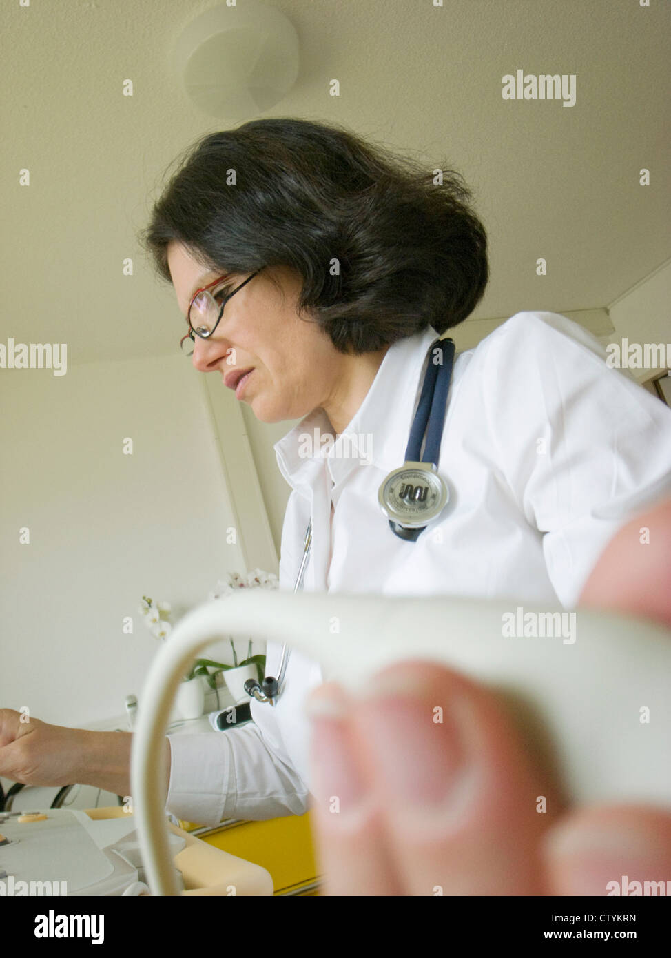 Patients view of a female cardiologist using ultrasound Stock Photo - Alamy