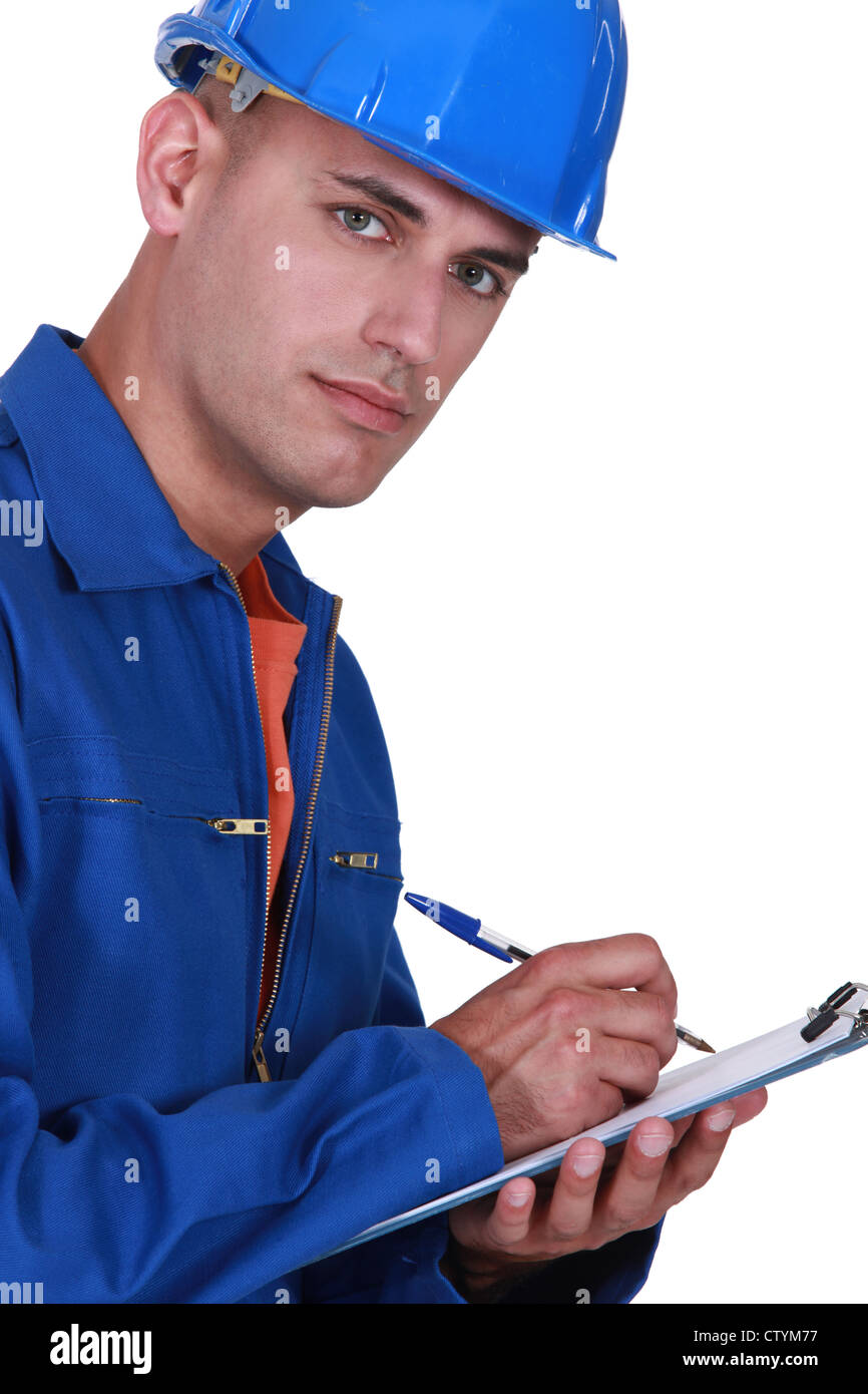 Inspector writing on clip-board Stock Photo - Alamy