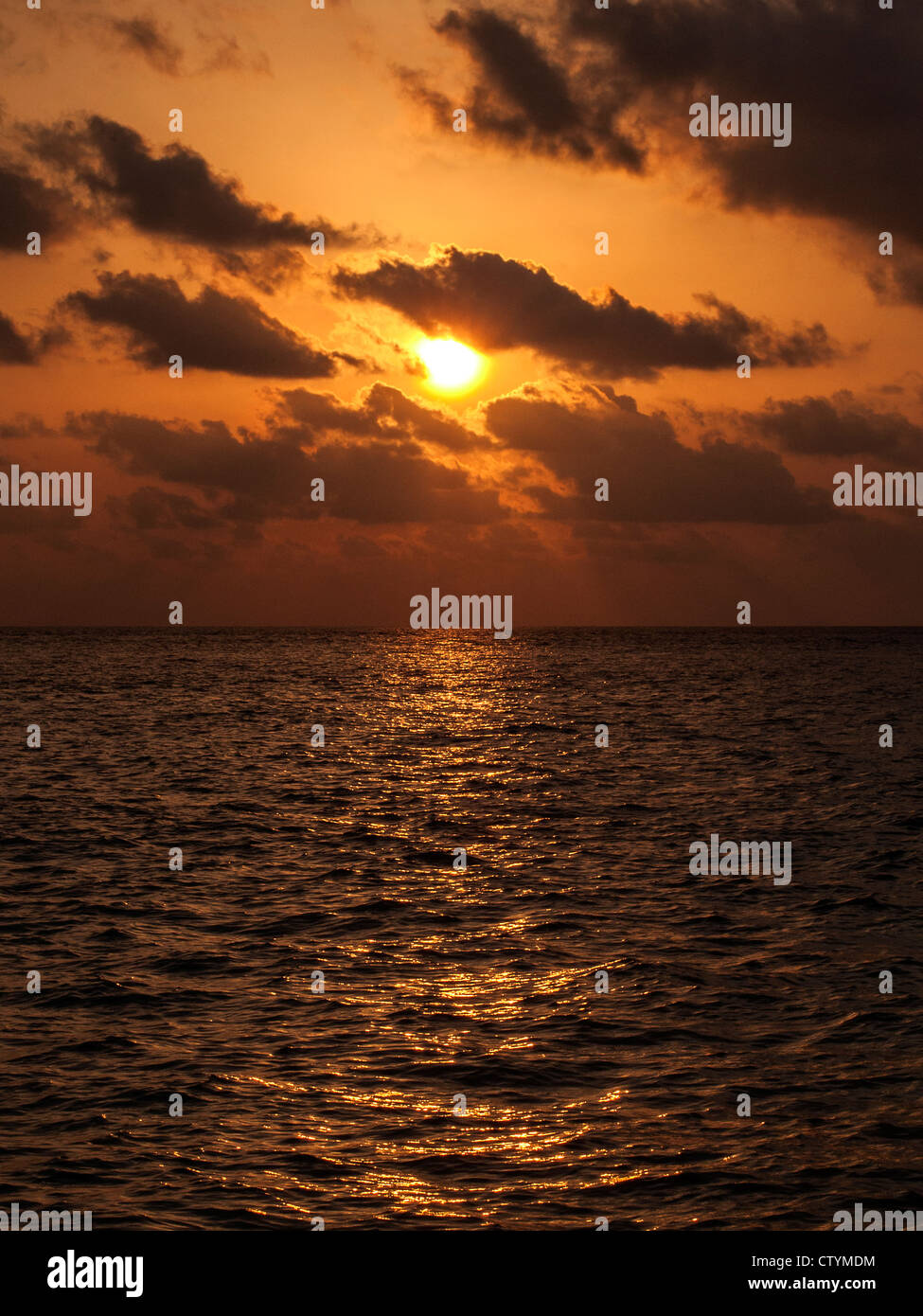 sun set over thee indian ocean in the maldives Stock Photo - Alamy