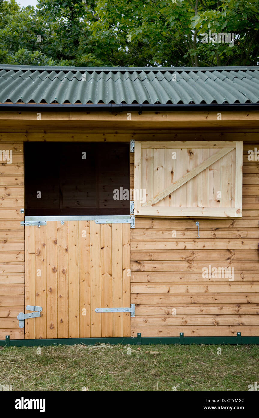 A brand new wooden mobile filed stable with built in tack room on skids ...