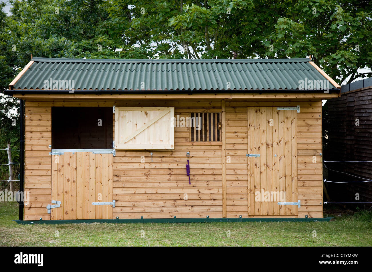 A brand new wooden mobile filed stable with built in tack room on skids ...