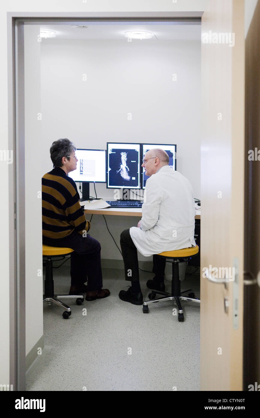 Radiologist consulting a patient in radiology department of a hospital ...